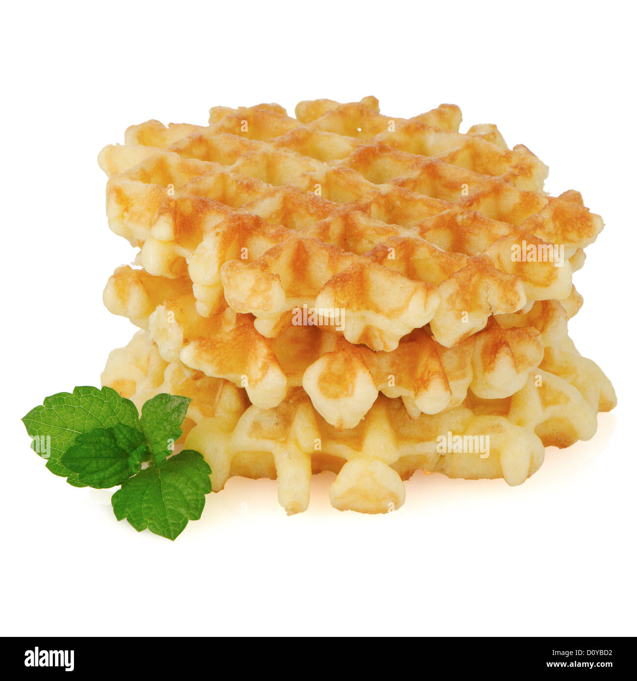 Pile of sweet waffles with green mint leaves isolated on white ...