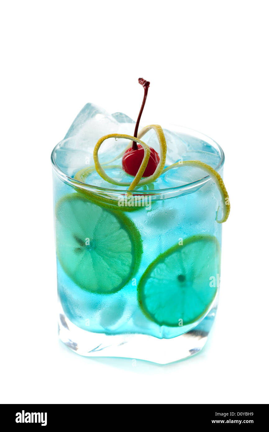 Blue alcohol cocktail with lemon and maraschino slices isolated on ...