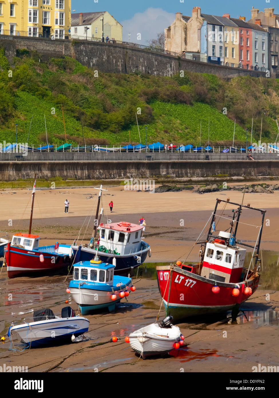 View of small boats in the harbour and the Old Town in Tenby ...