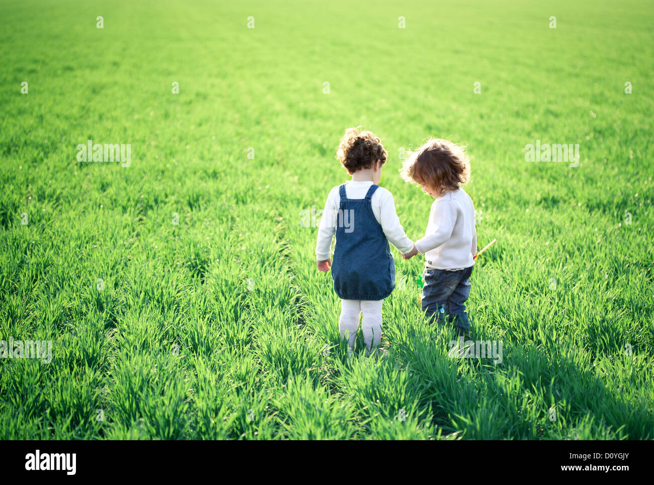 Children in spring field Stock Photo - Alamy