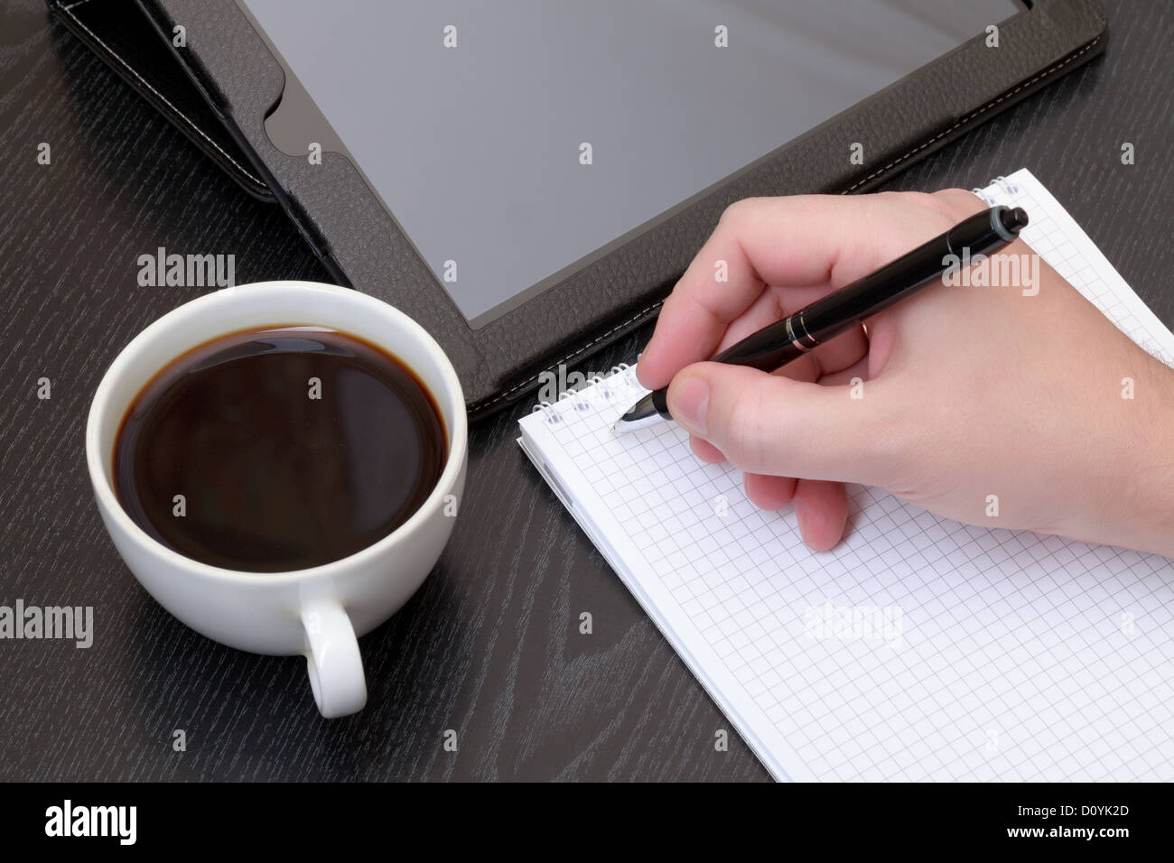 Closeup of a male hand writing notes on notepad Stock Photo - Alamy