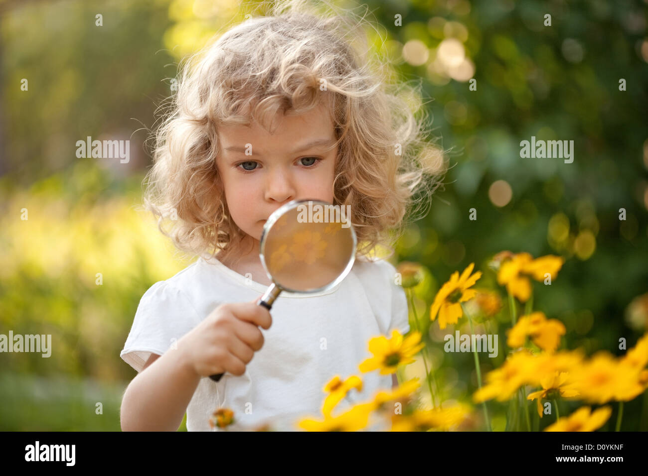 Child explorer flowers in garden Stock Photo - Alamy