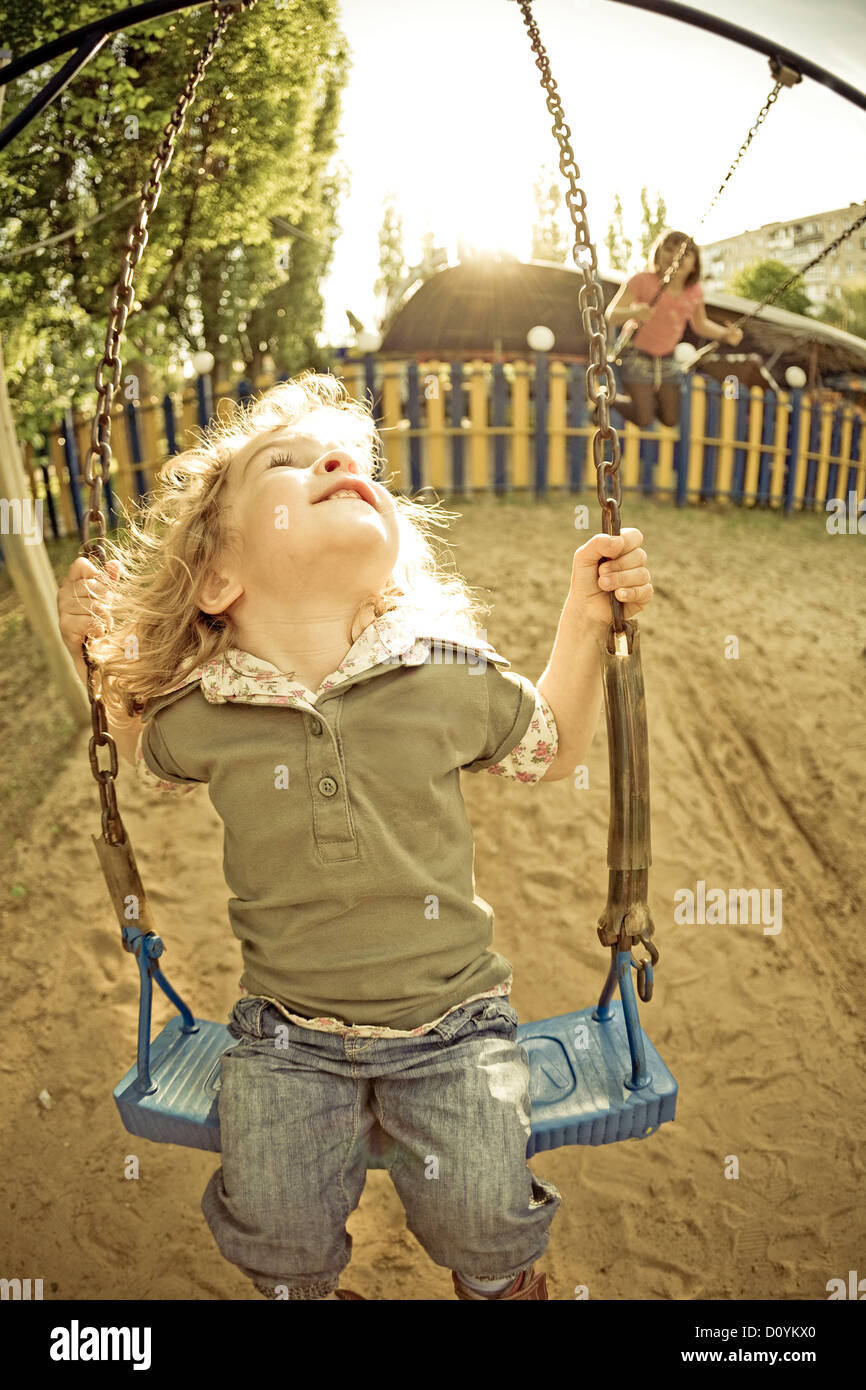 Child on swing in summer Stock Photo - Alamy