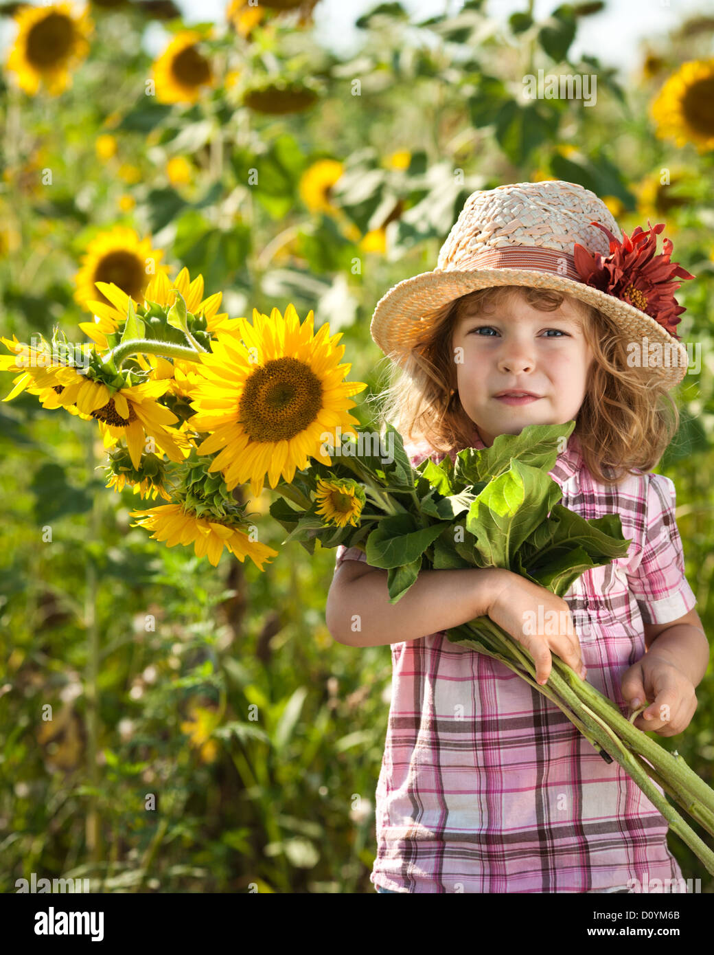 Child with bunch of sunflowers Stock Photo - Alamy
