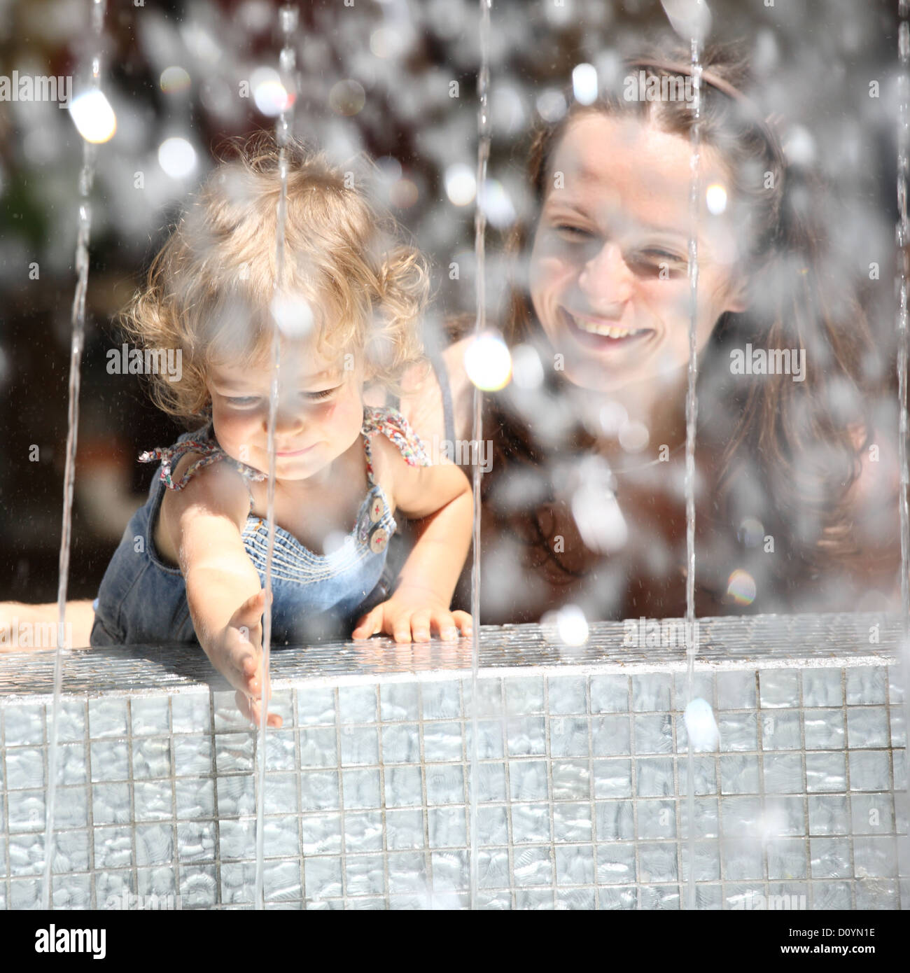 Young girls playing with the fountain hi-res stock photography and ...