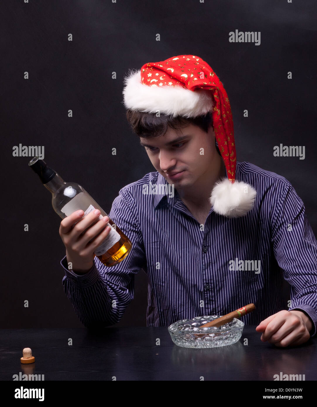 man drinks alcohol and smokes a cigar Stock Photo - Alamy