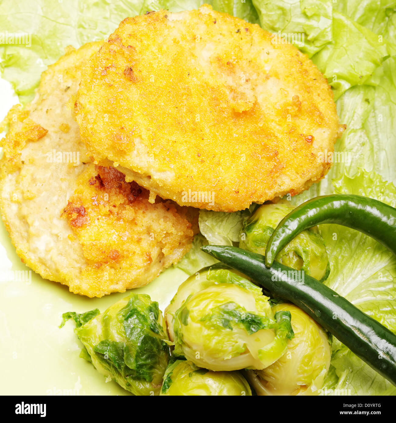 Chicken cutlets with brussels sprout Stock Photo - Alamy