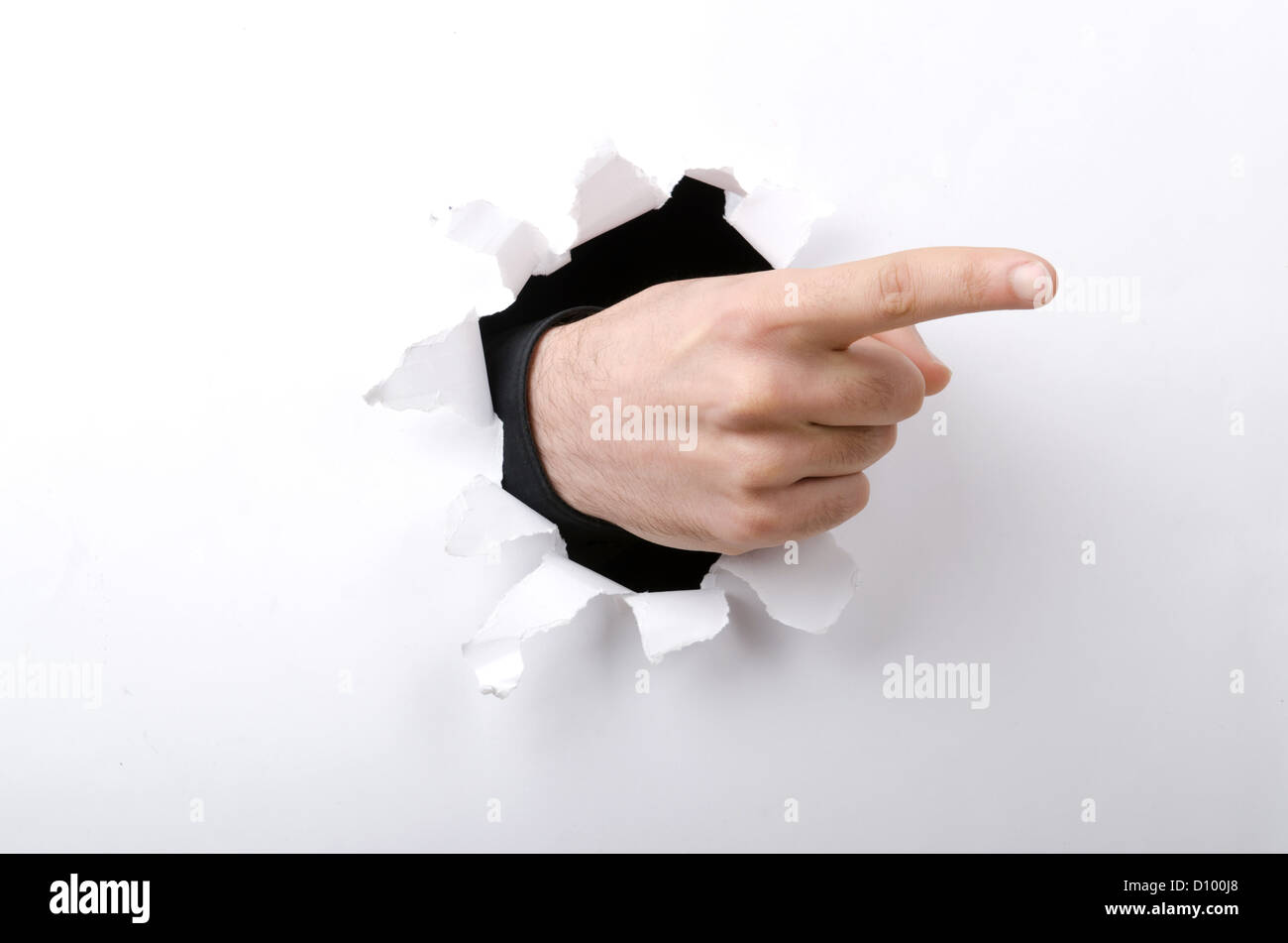 Hand through the hole in paper Stock Photo - Alamy