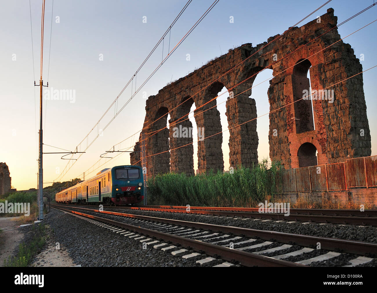 A train go near the Roman aqueduct, Aqueduct park, Appia Way, Rome ...