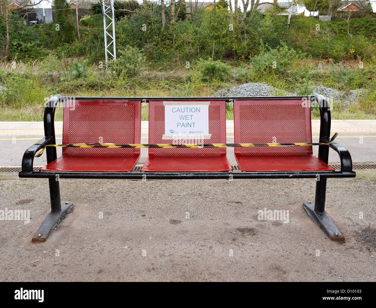 Caution wet paint warning on railway station platform bench in Sandbach ...