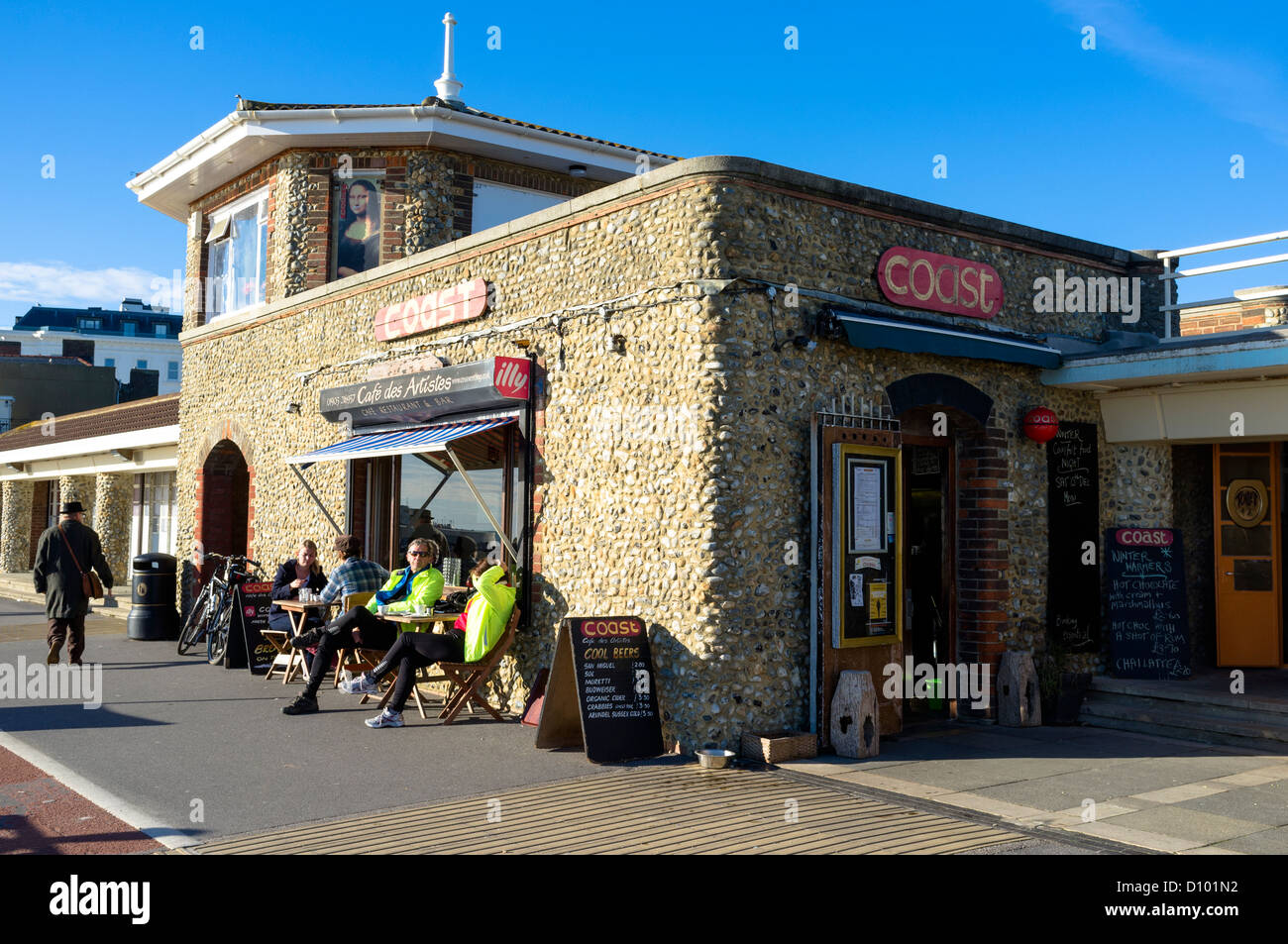 People relax outside "coast" seafront cafe on a sunny sunday morning 02 ...