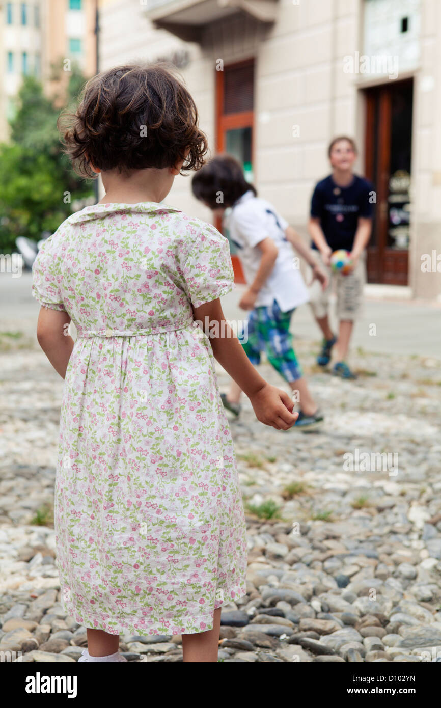 Kids playing with a ball outdoor in the street Stock Photo - Alamy