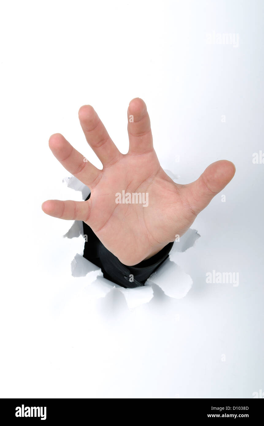 Hand through the hole in paper Stock Photo - Alamy