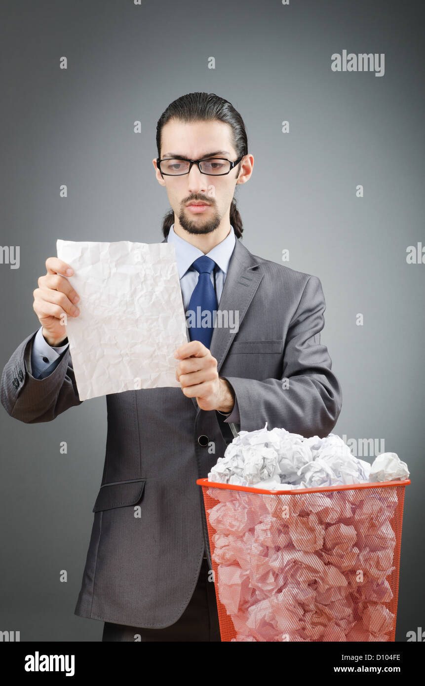 Man with lots of wasted paper Stock Photo - Alamy