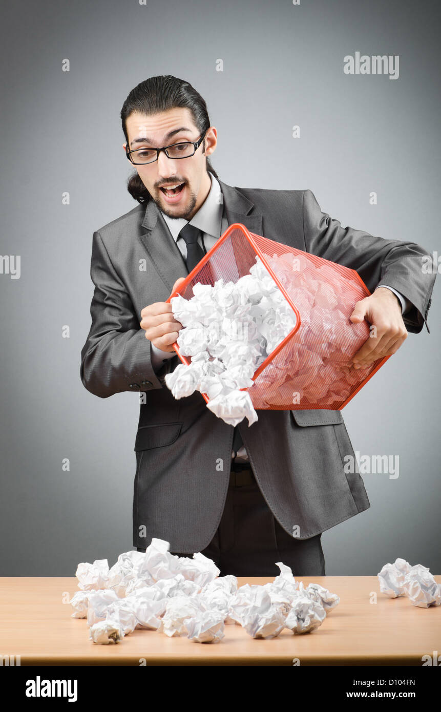 Man with lots of wasted paper Stock Photo - Alamy
