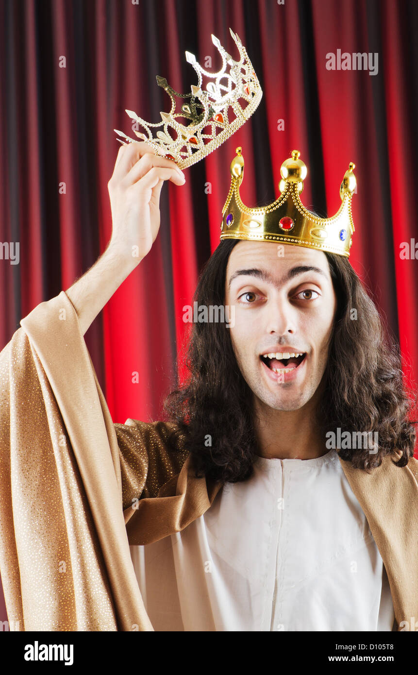 Funny king against red curtain Stock Photo - Alamy