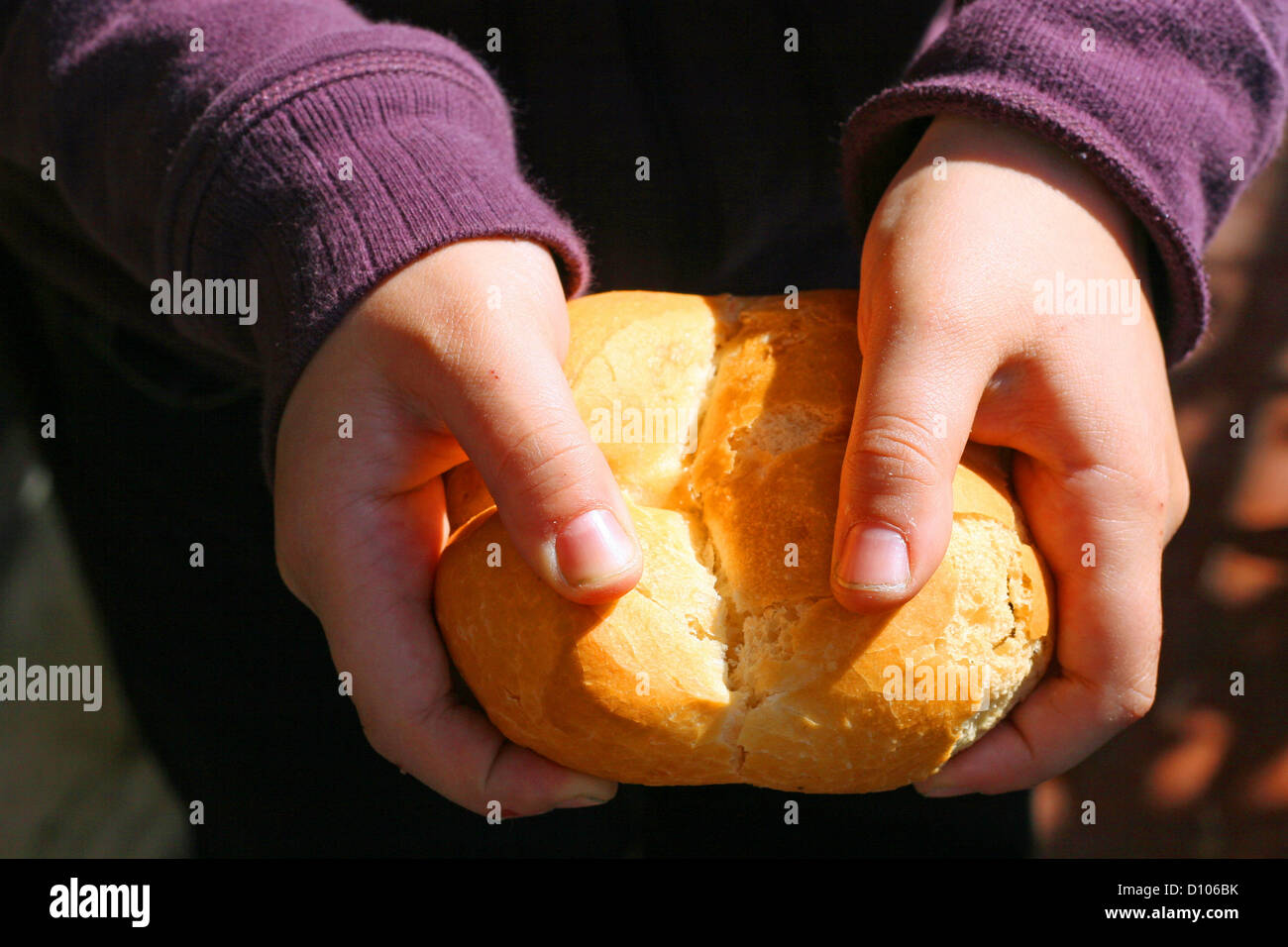child who breaks a piece of bread with your hands Stock Photo - Alamy