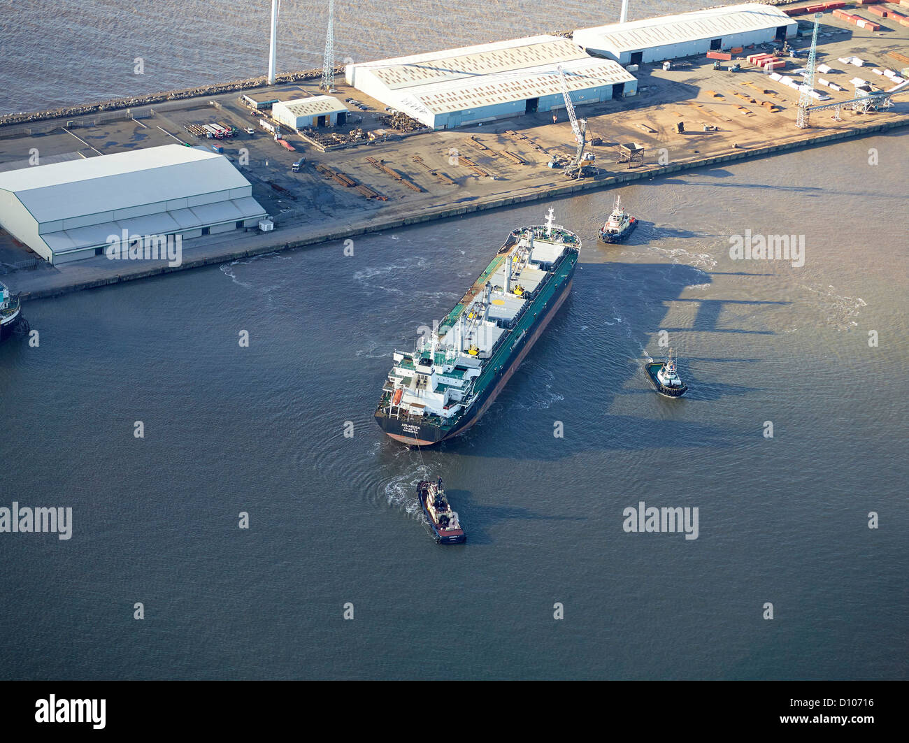 Ship being manouvered by tug boats in Liverpool Docks, Merseyside ...