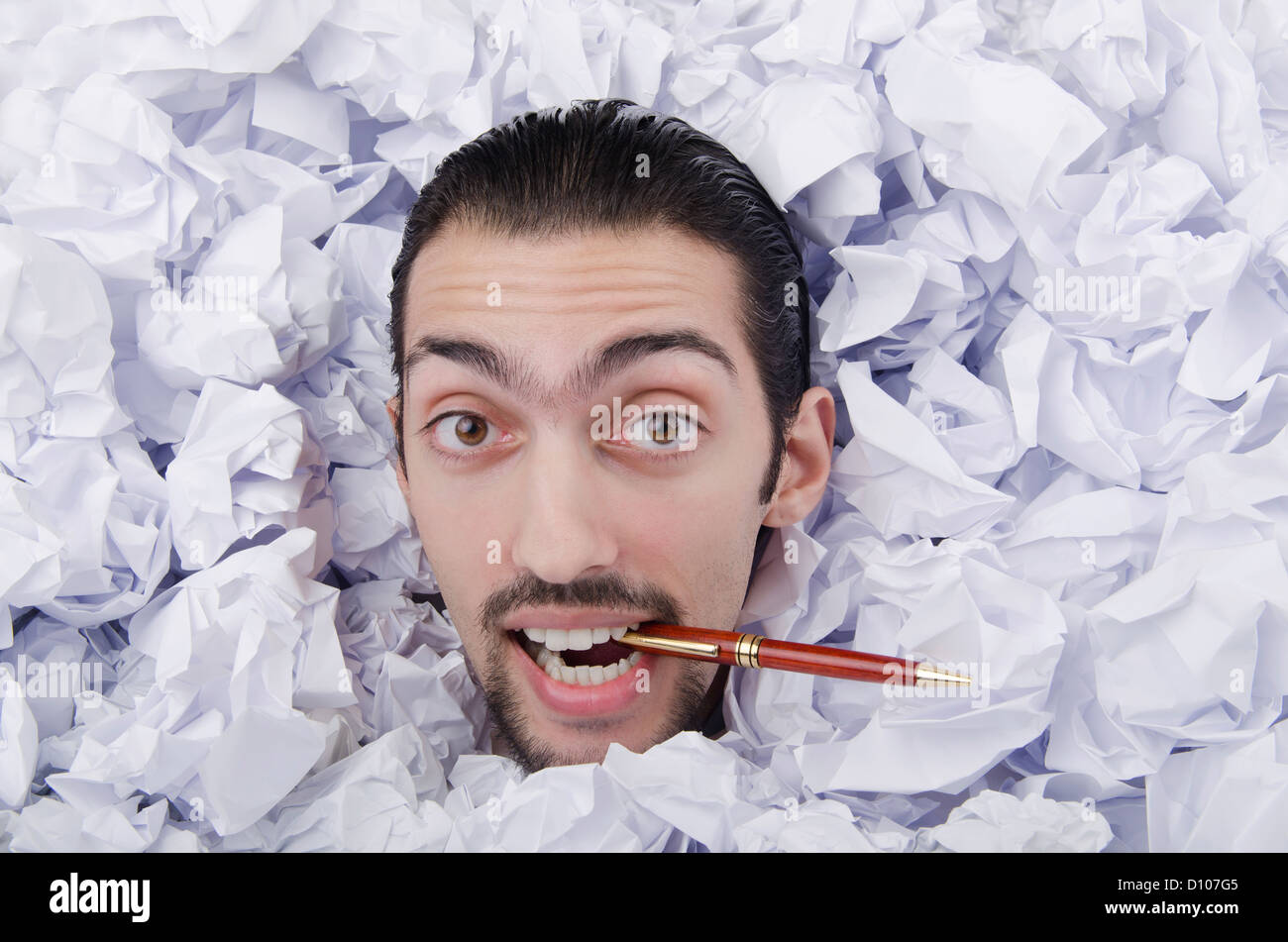 Man with lots of crumpled paper Stock Photo - Alamy