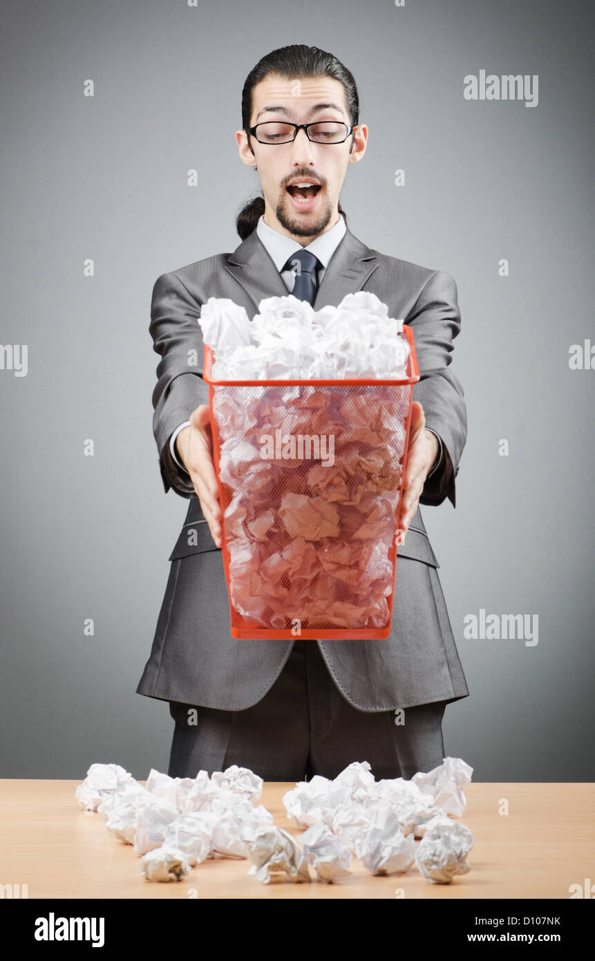Man with lots of wasted paper Stock Photo - Alamy