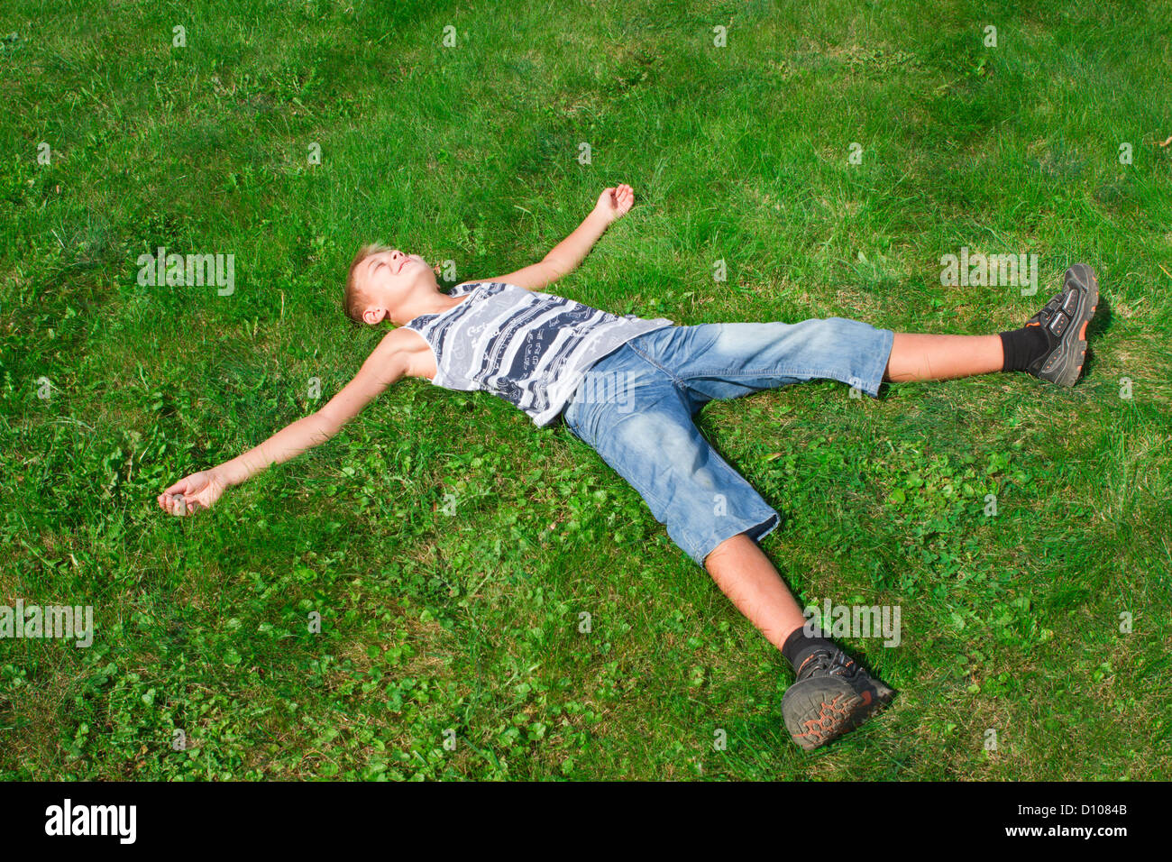 happy boy lying on the grass outdoors Stock Photo - Alamy