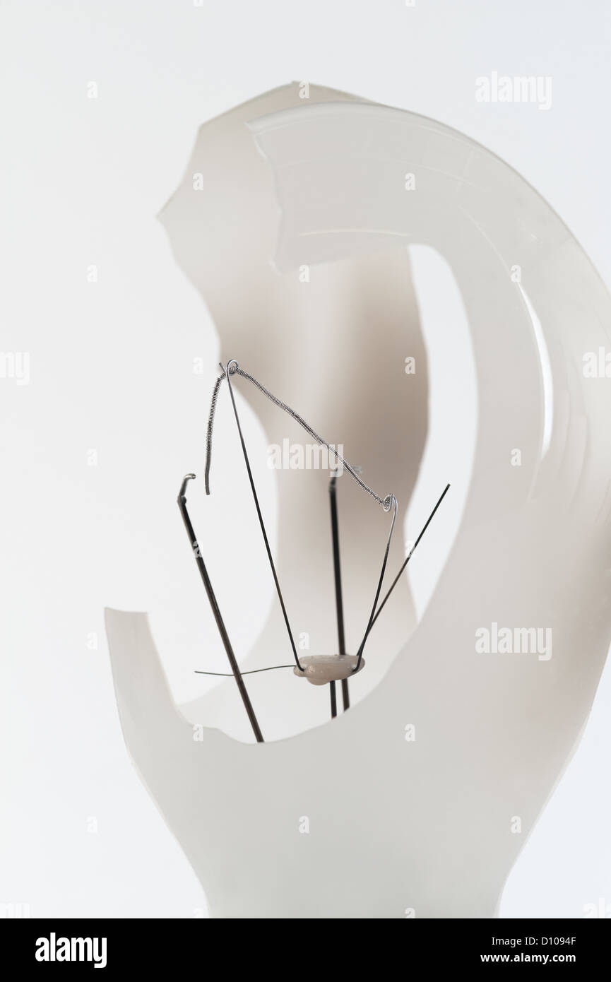 Broken incandescent tungsten filament light bulb shattered glass with ...