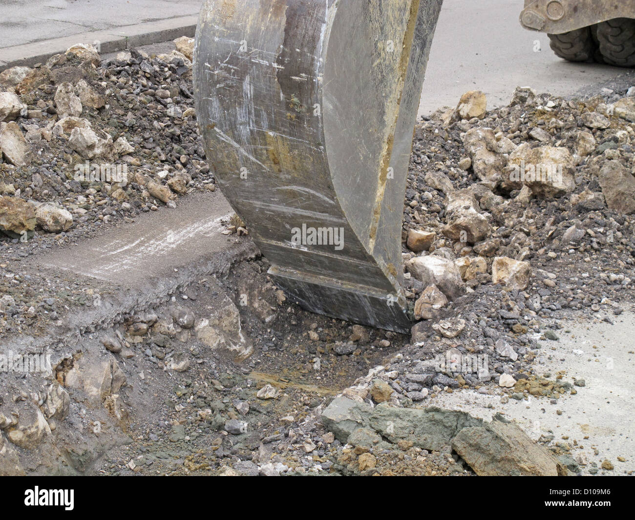 metal scraper bucket during the removal of pebbles in a construction ...