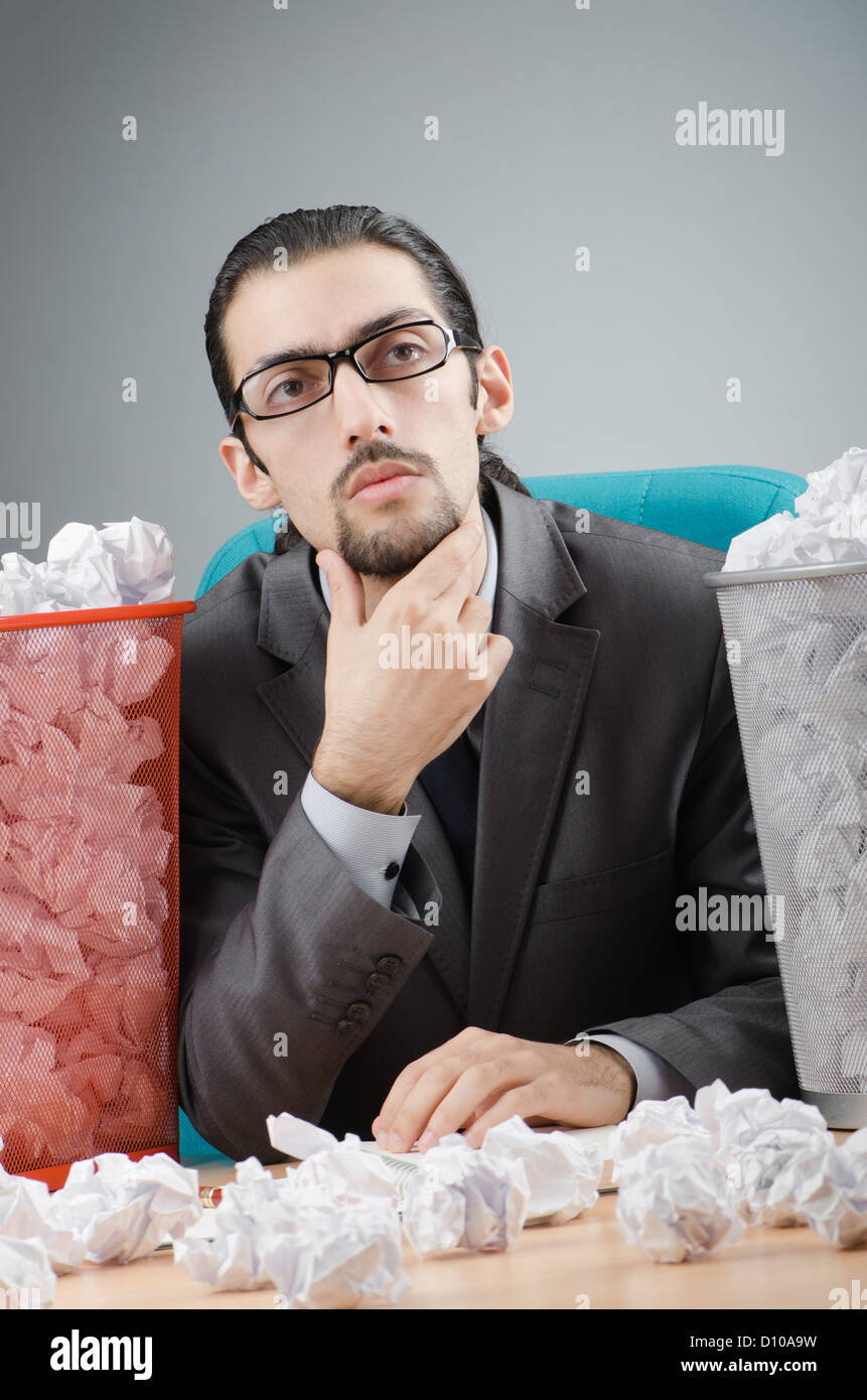 Man with lots of wasted paper Stock Photo - Alamy