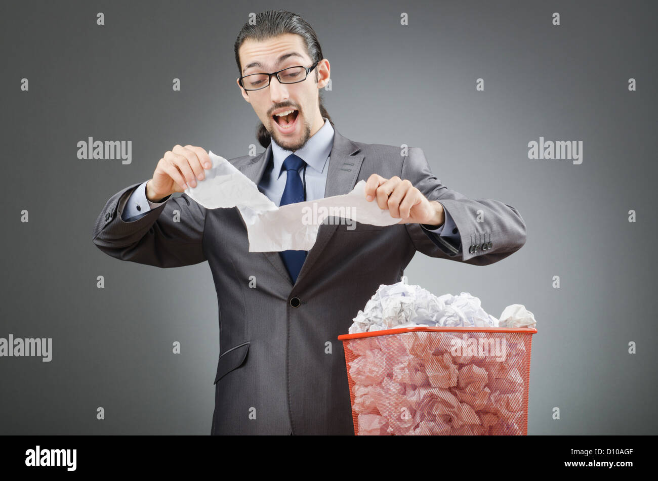 Man with lots of wasted paper Stock Photo - Alamy