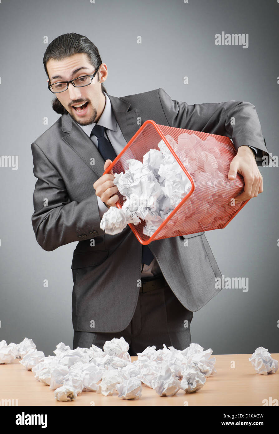 Man with lots of wasted paper Stock Photo - Alamy