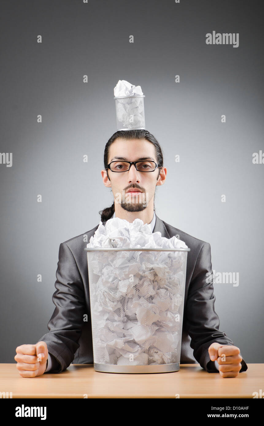 Man with lots of wasted paper Stock Photo - Alamy