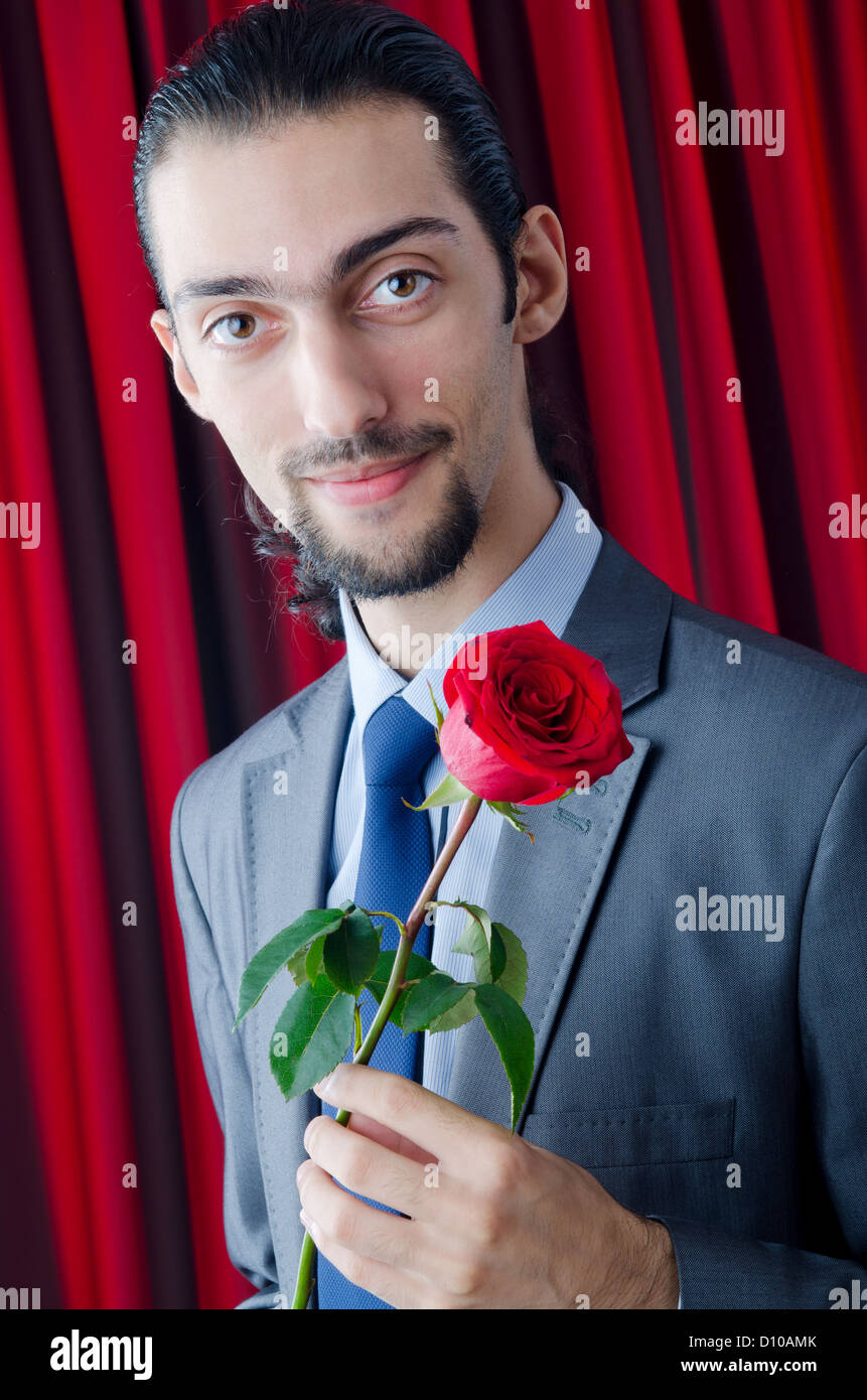 Young man with red rose Stock Photo - Alamy