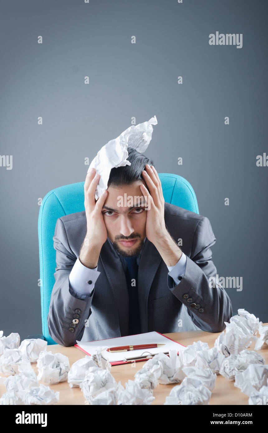 Businessman with lot of discarded paper Stock Photo - Alamy
