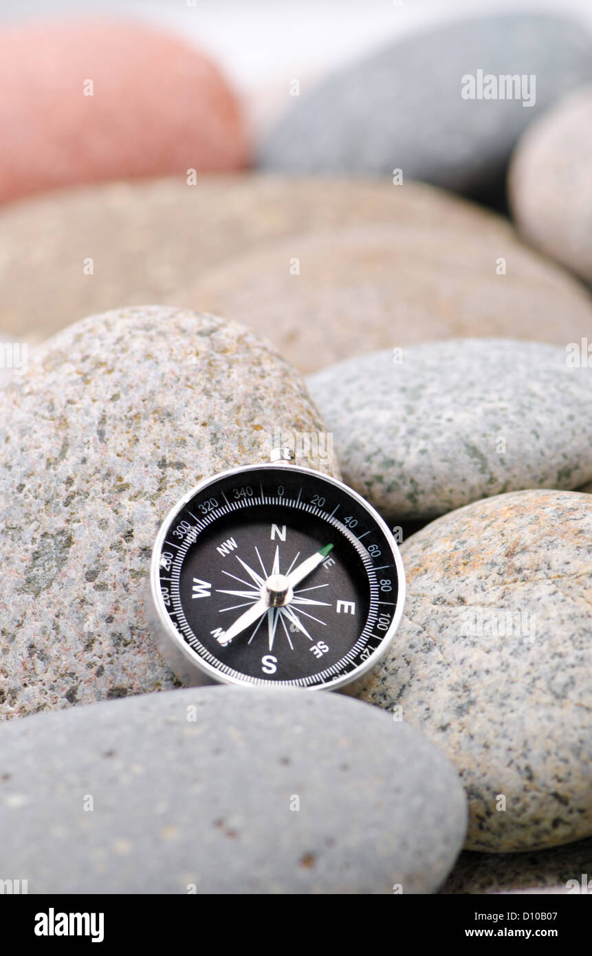 Navigation compass on stone pebbles Stock Photo - Alamy