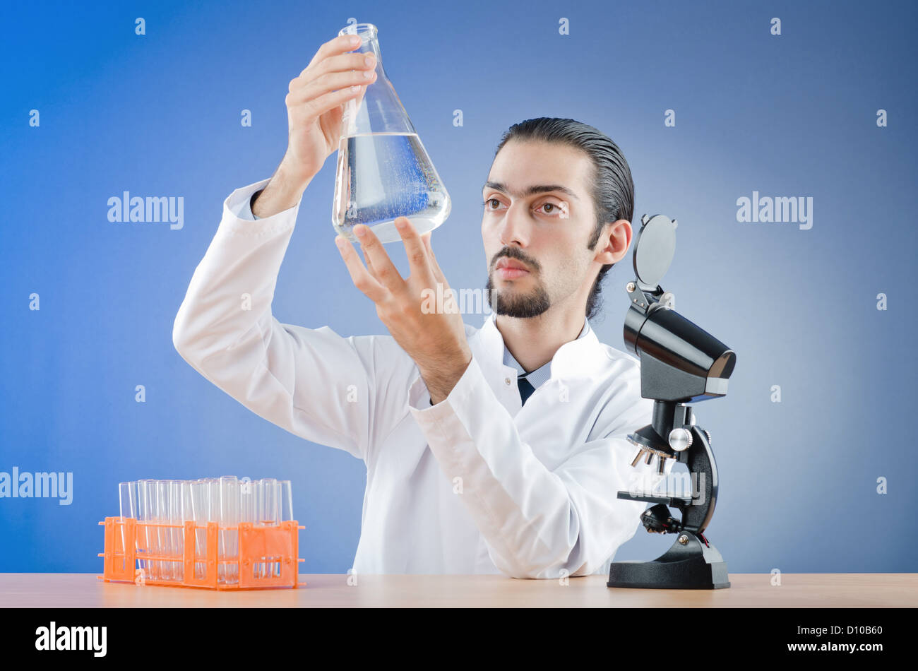 Chemist working with microscope Stock Photo - Alamy