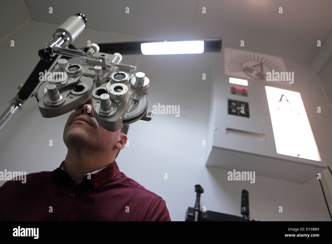 Young male caucasian man patient having eye sight examination test with ...