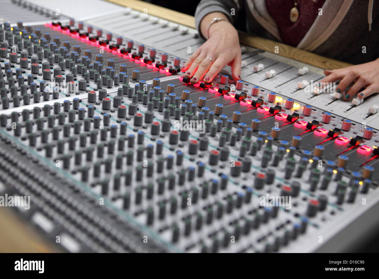 Female hands, using sound mixing desk, close-up detail, UK Stock Photo ...