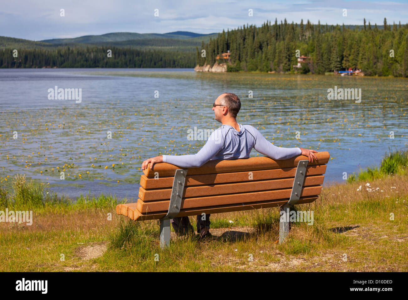 Man on summer lake Stock Photo - Alamy
