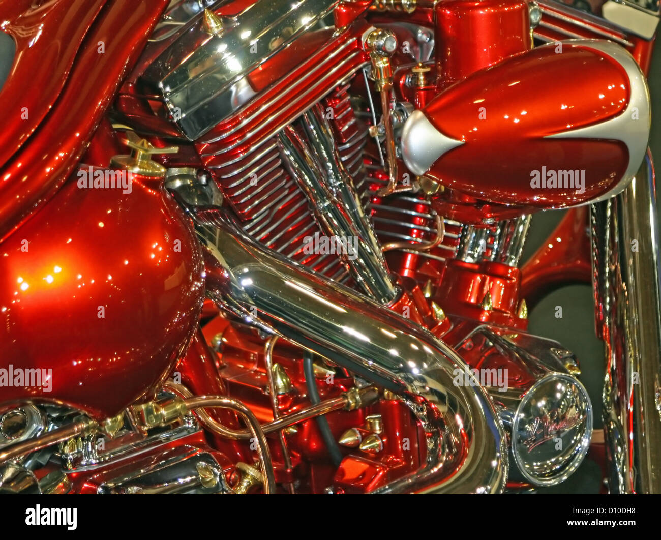 engine of a motorcycle with red and gold details photographed at close ...