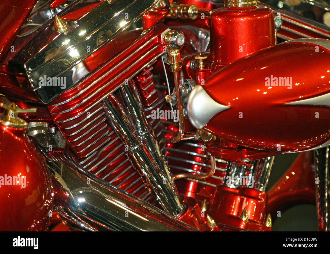 engine of a motorcycle with red and gold details photographed at close ...