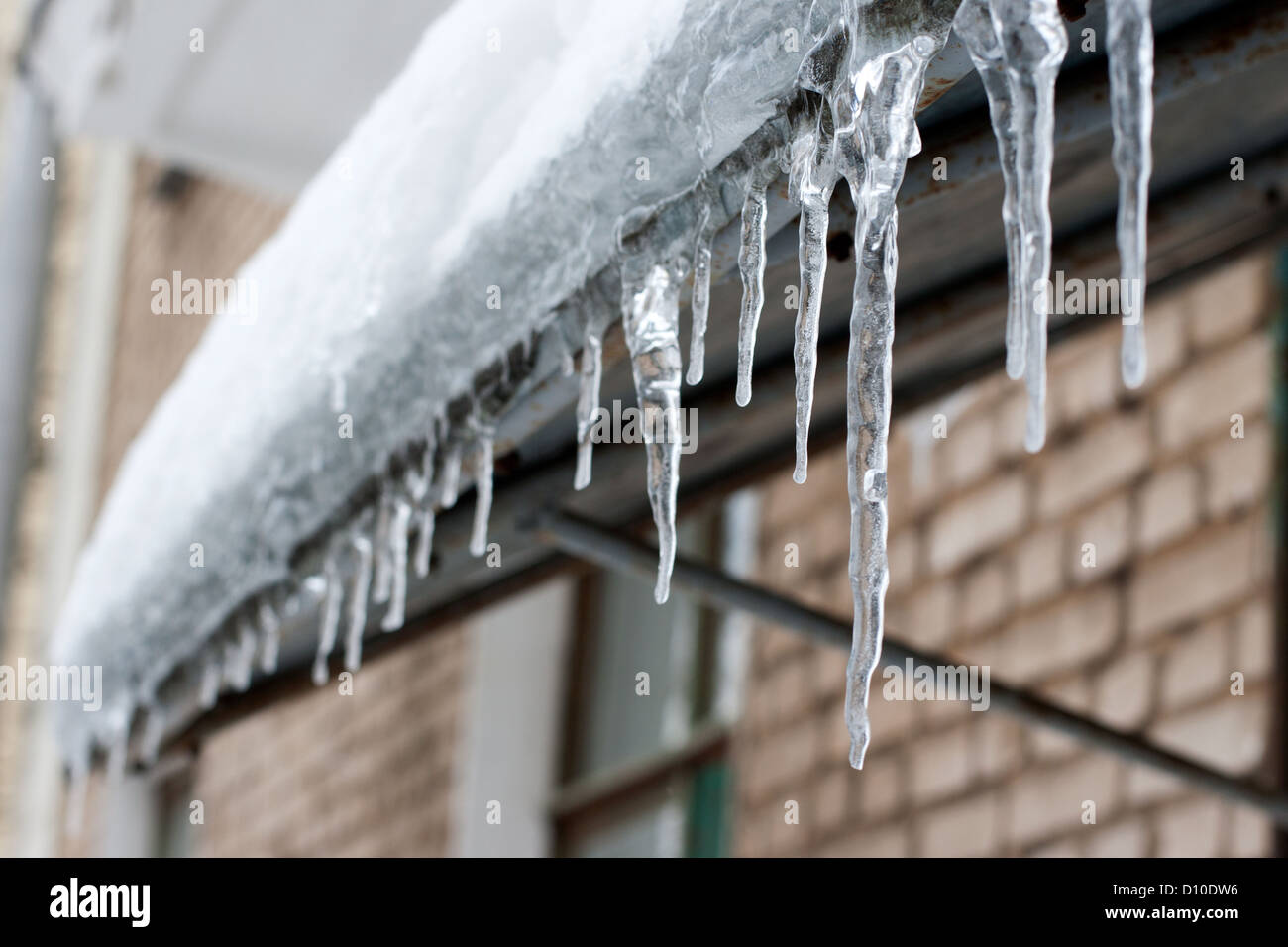 icicles which are hanging down from a roof Stock Photo - Alamy