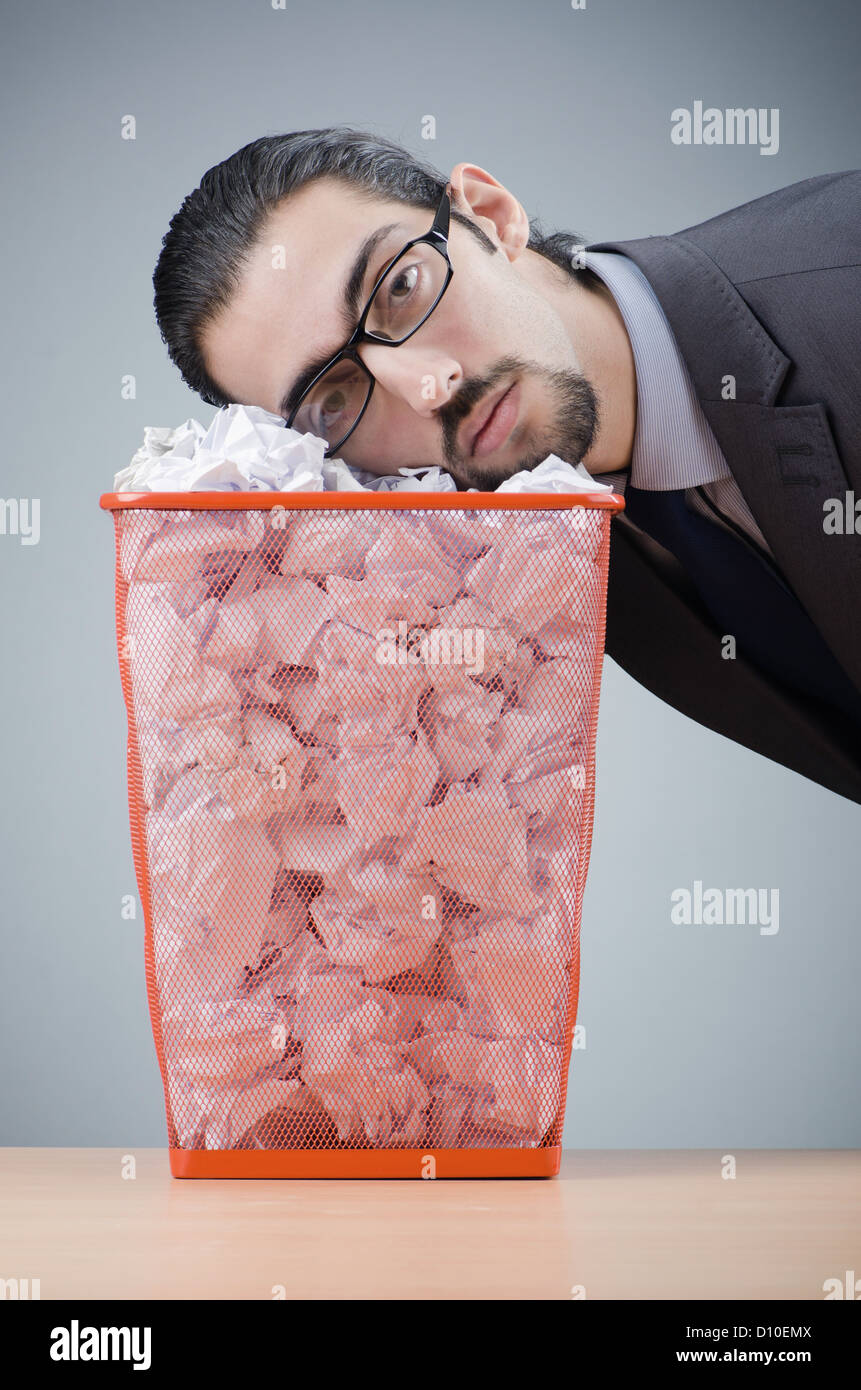 Man with lots of wasted paper Stock Photo - Alamy