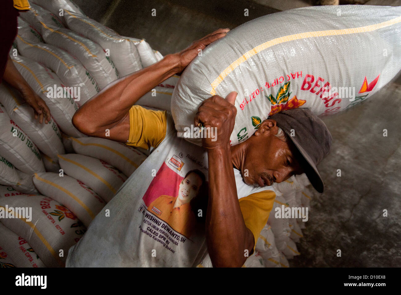 Workers loading sacks of rice at exporter's warehouse. Indonesia Stock ...