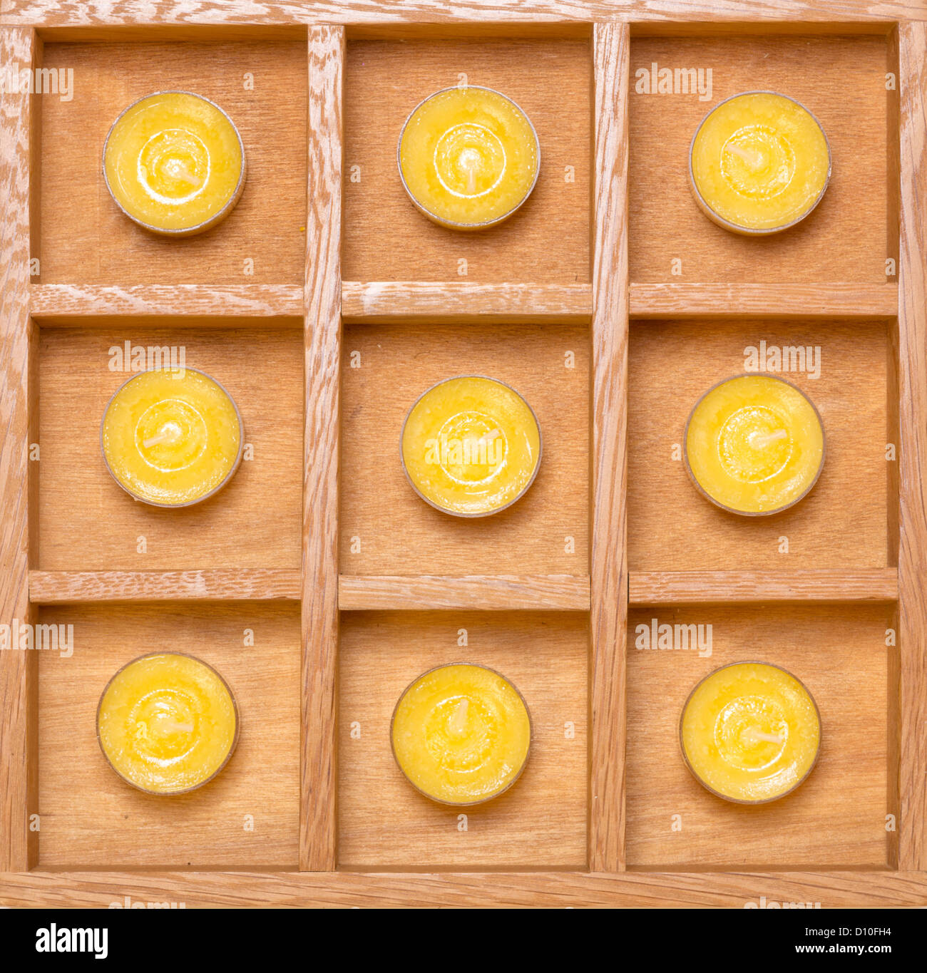 A shadow box displaying a group of yellow candles Stock Photo - Alamy