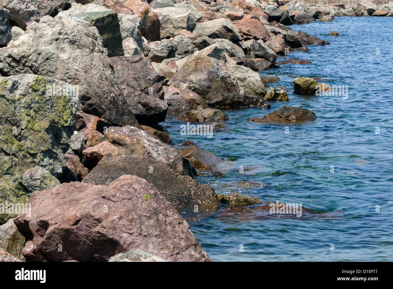 Coast of Mediterranean sea with big stones in water Stock Photo - Alamy