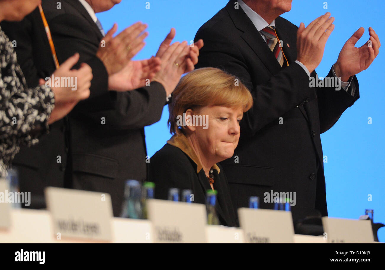 German Chancellor Angela Merkel receives a standing ovation after ...