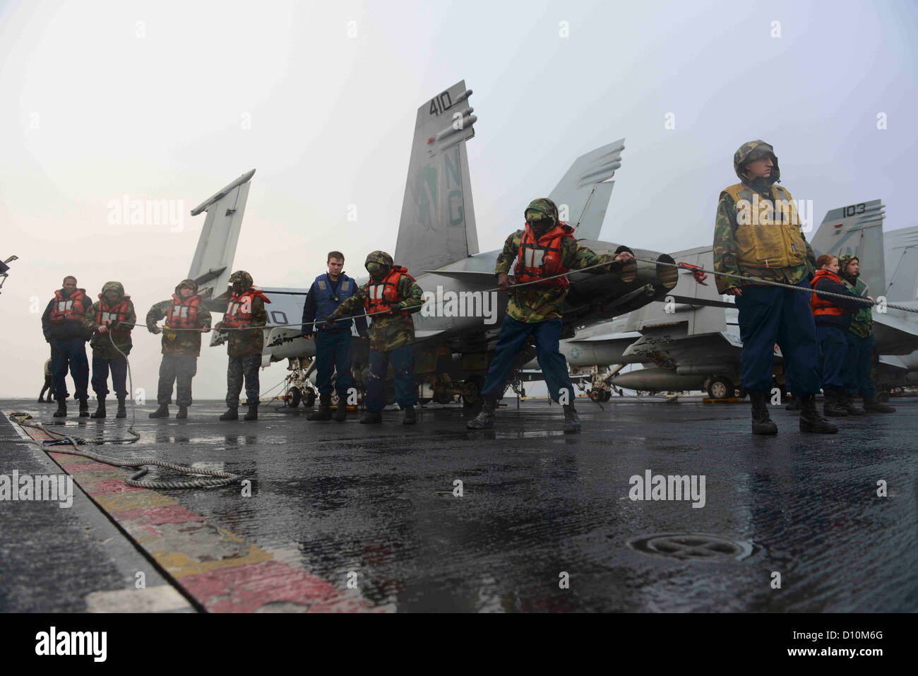 Sailors aboard the USS John C. Stennis manage a replenishment-at-sea ...