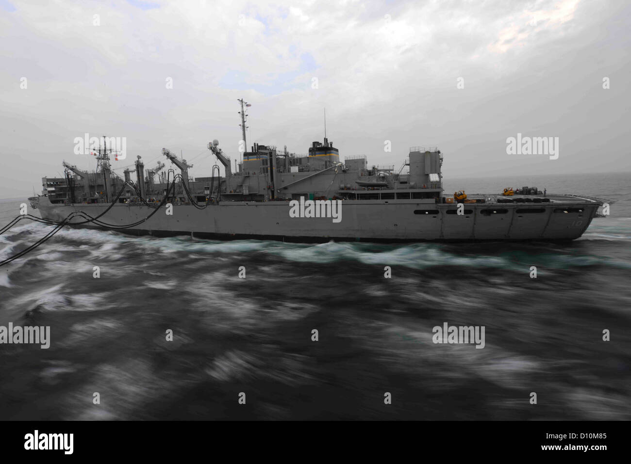 The Military Sealift Command fast combat support ship USNS Bridge (T-AOE 10) steams alongside ...