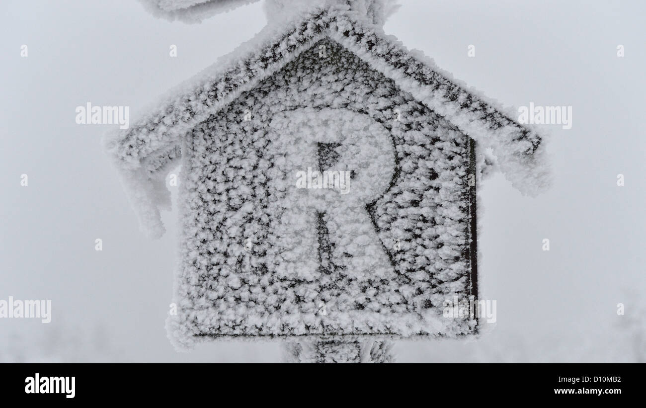 A road sign with the letter 'r' is covered in snow on Inselberg Hill in ...
