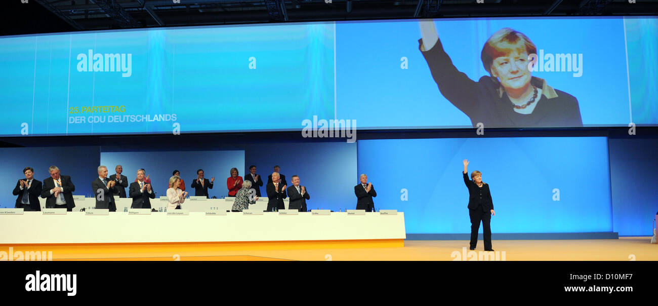 German Chancellor Angela Merkel (R, back) waves to the audience after ...